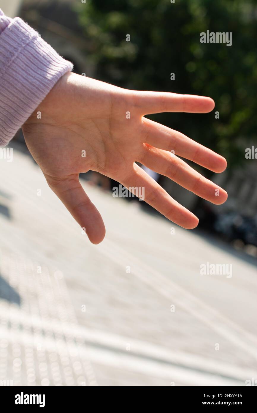 Vertical closeup shot of a female giving her hand to the person next to ...