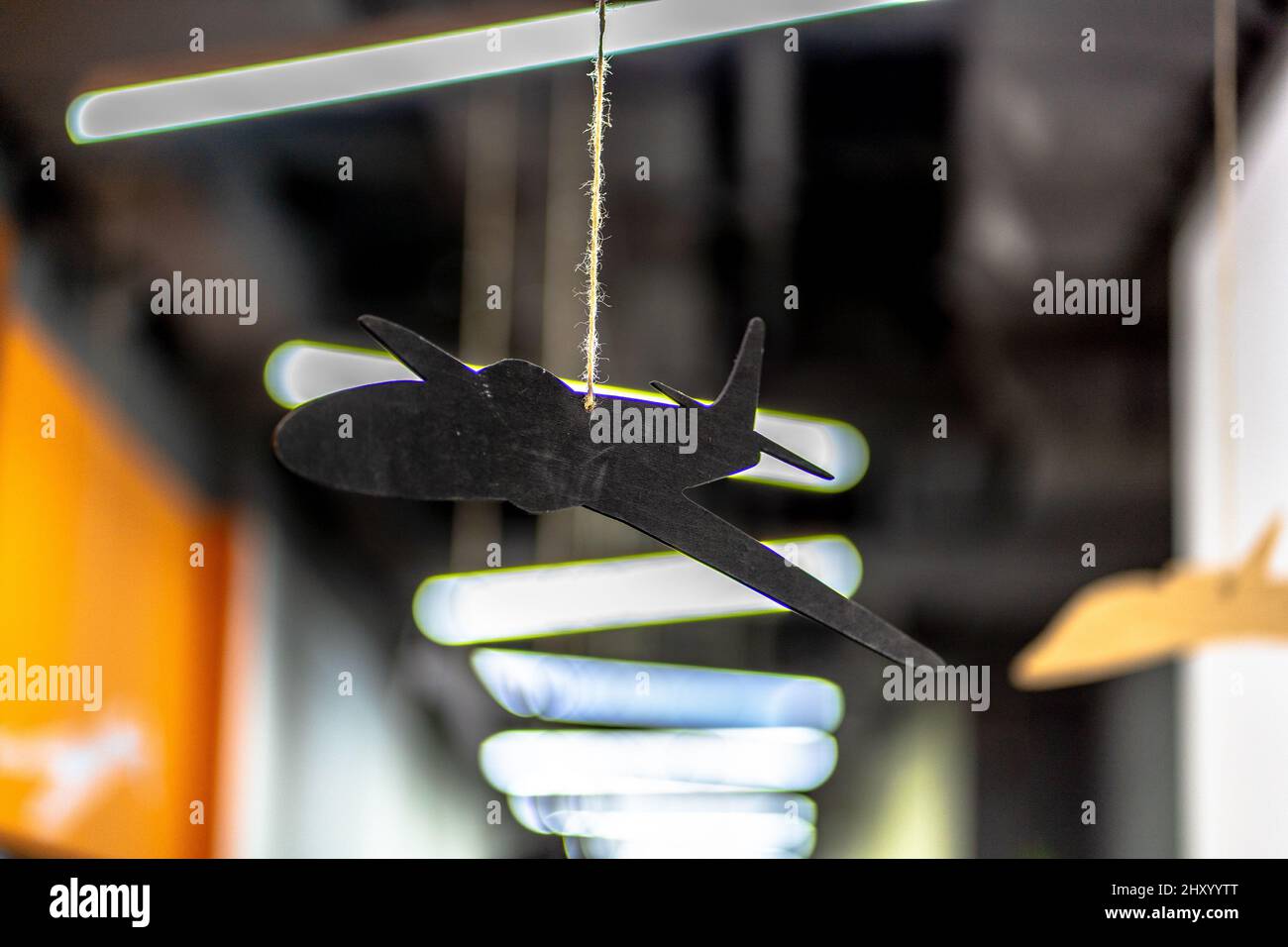 Selective of a paper plane hanging in a cafe Stock Photo - Alamy