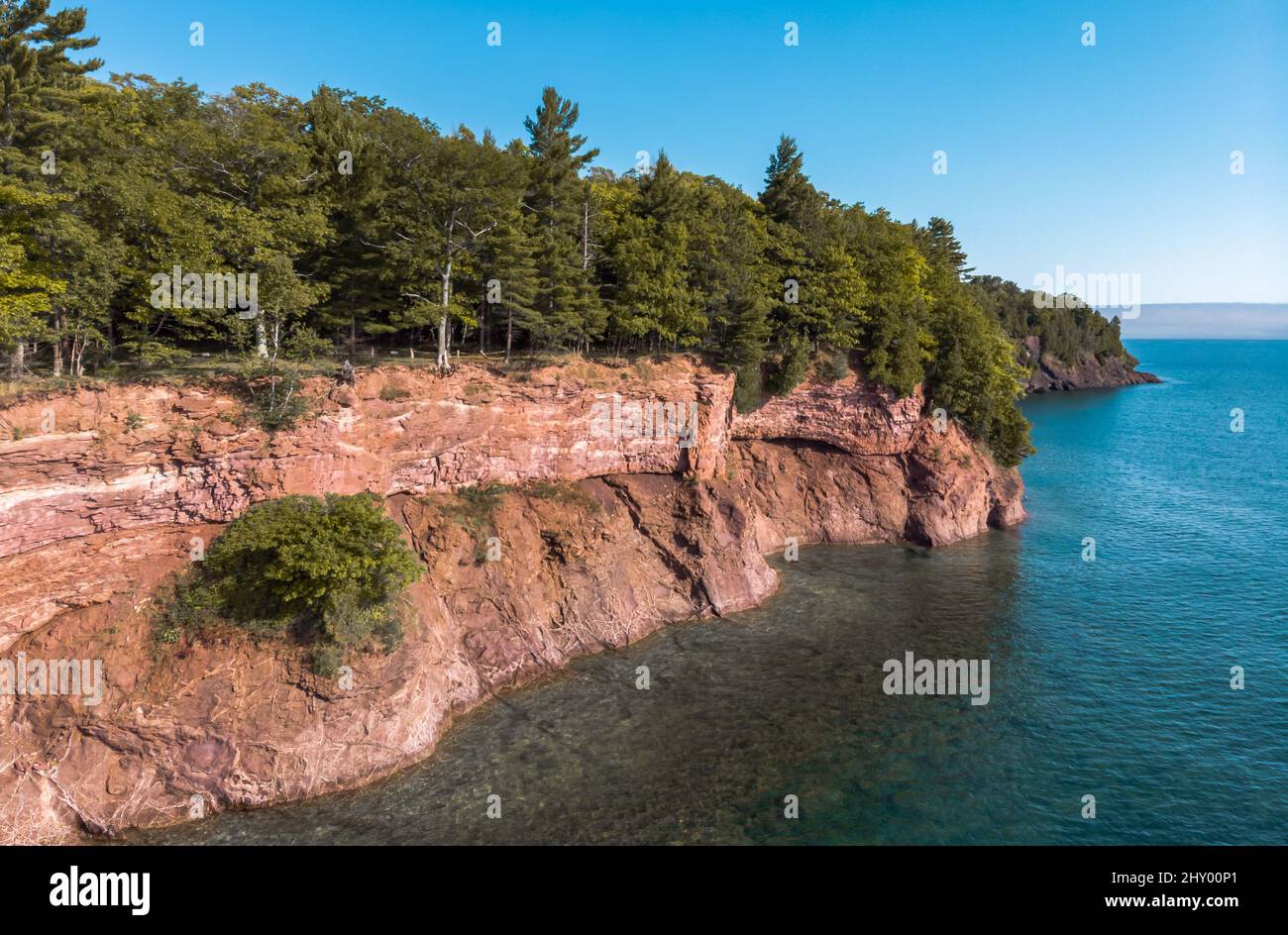 Beautiful landscape of green forests on the edge of a cliff near a lake ...