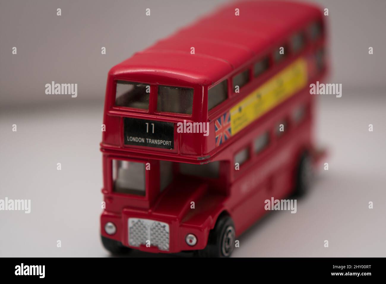 Selective of London red bus toy on a white surface Stock Photo - Alamy