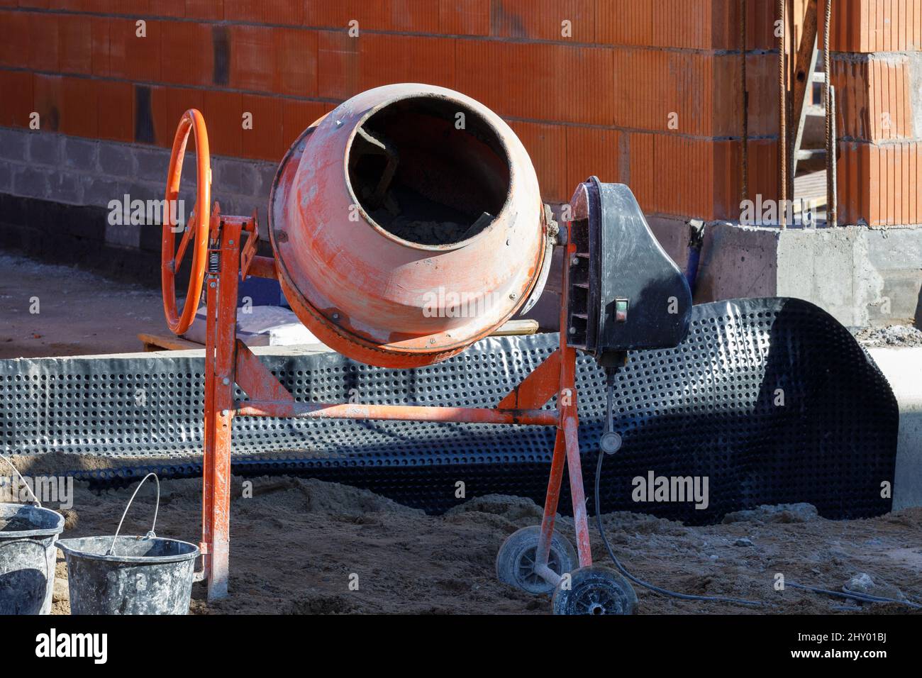 Orange metal container used in a construction site against an orange ...
