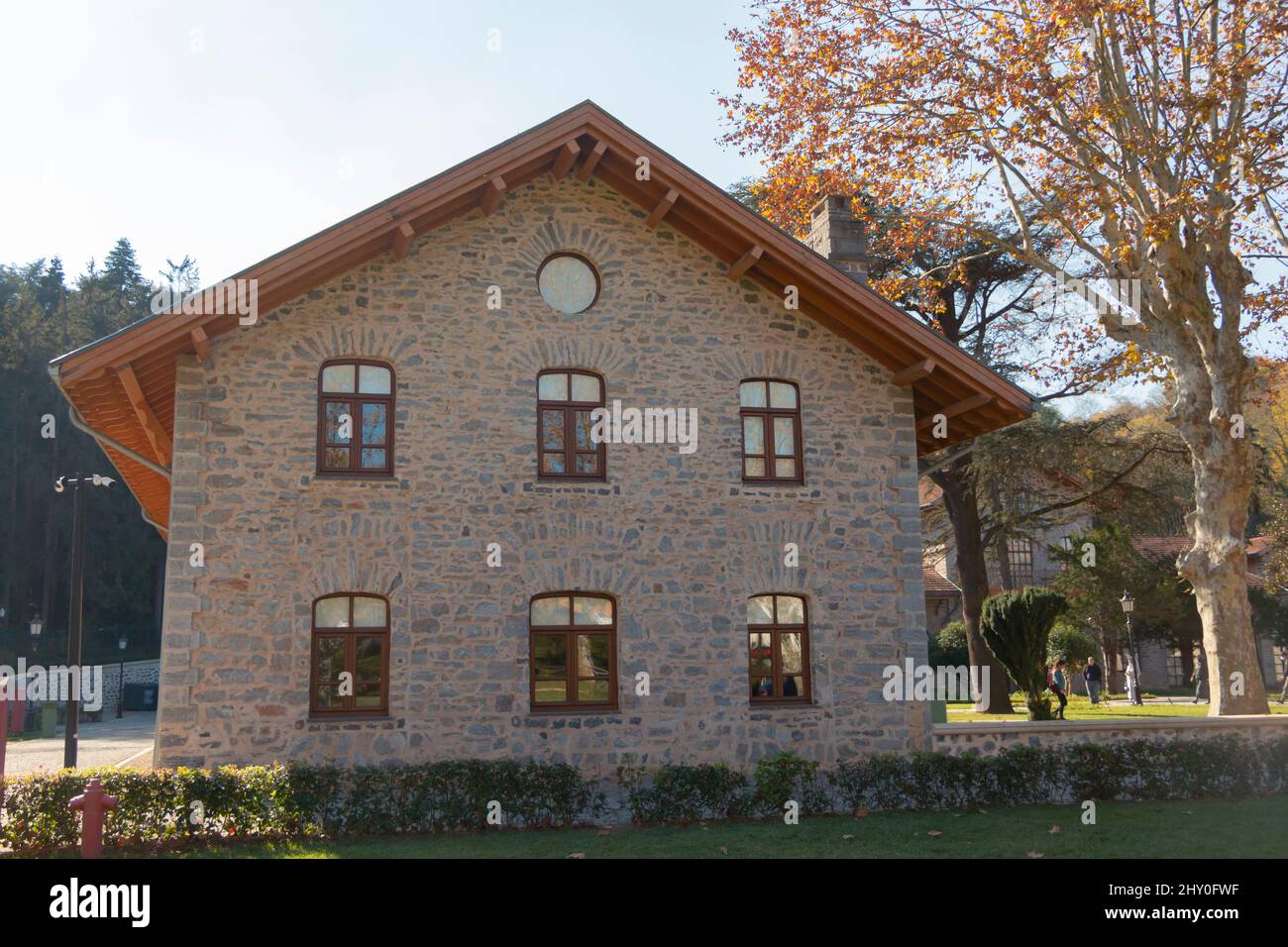 A beautiful huge house. Triangle roof. Stone house in autumn season ...
