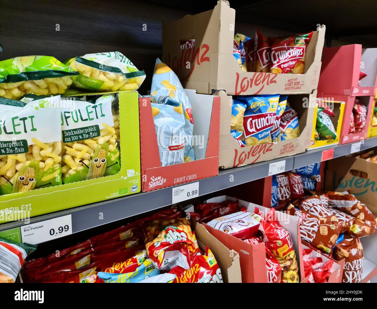 Variety of snacks display on a supermarket shelf Stock Photo - Alamy