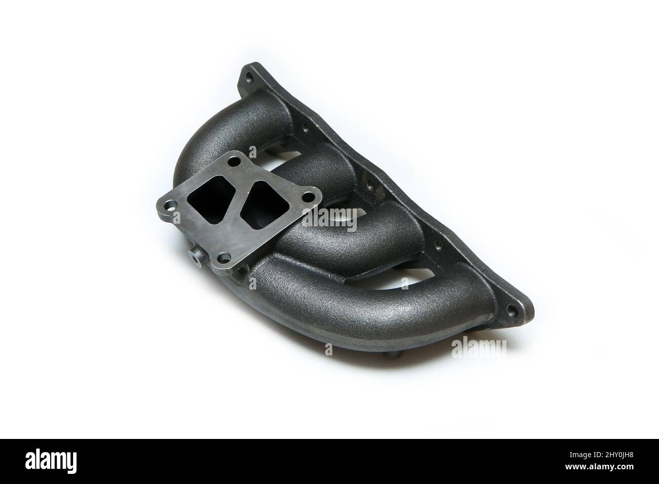 The new cast iron car engine air intake manifold isolated in a white ...