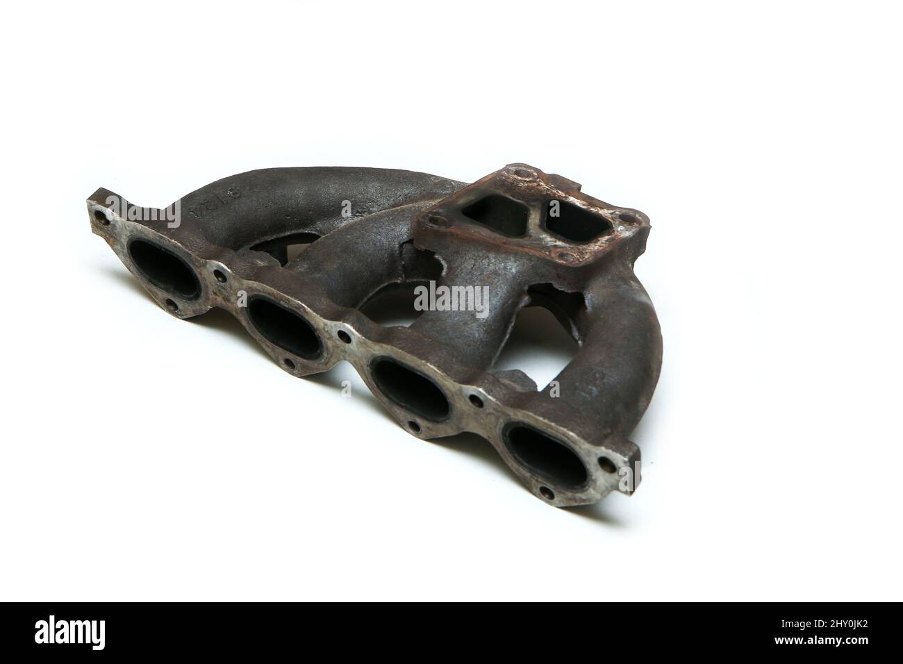 The used and rusty cast iron car engine air intake manifold isolated in ...