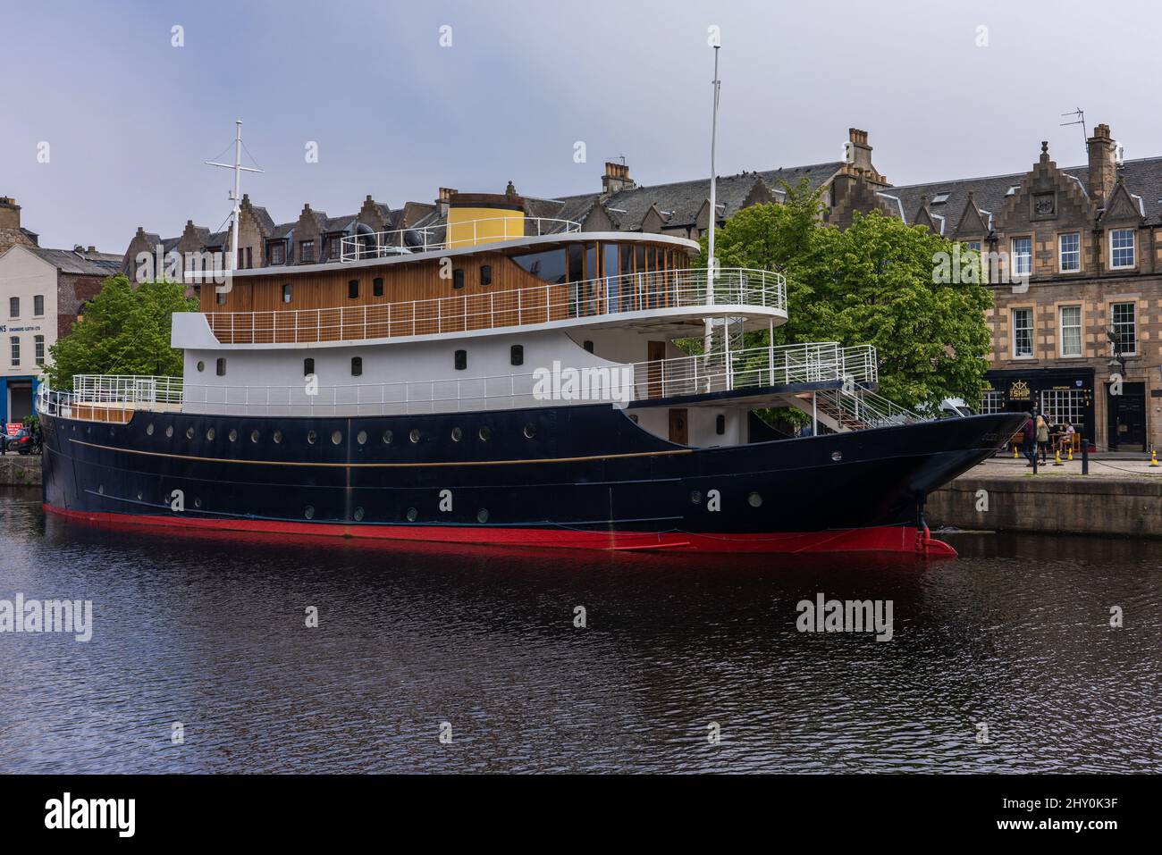 The Fingal, a floating hotel boat docked along the waterfront in Leith ...