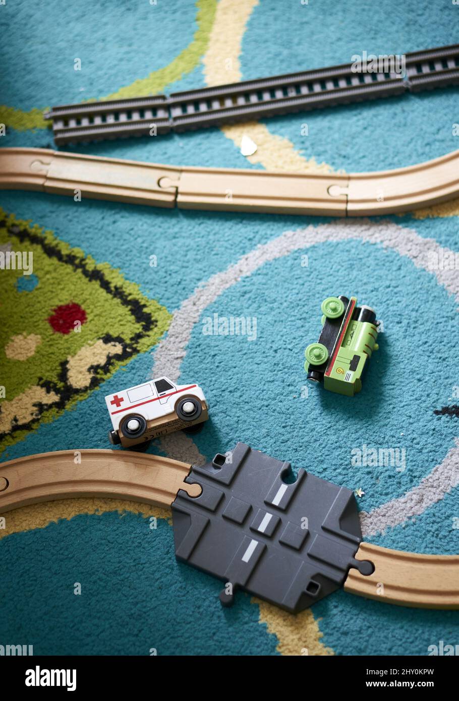 Wooden toy track with trains set laying on a carpet floor Stock Photo ...