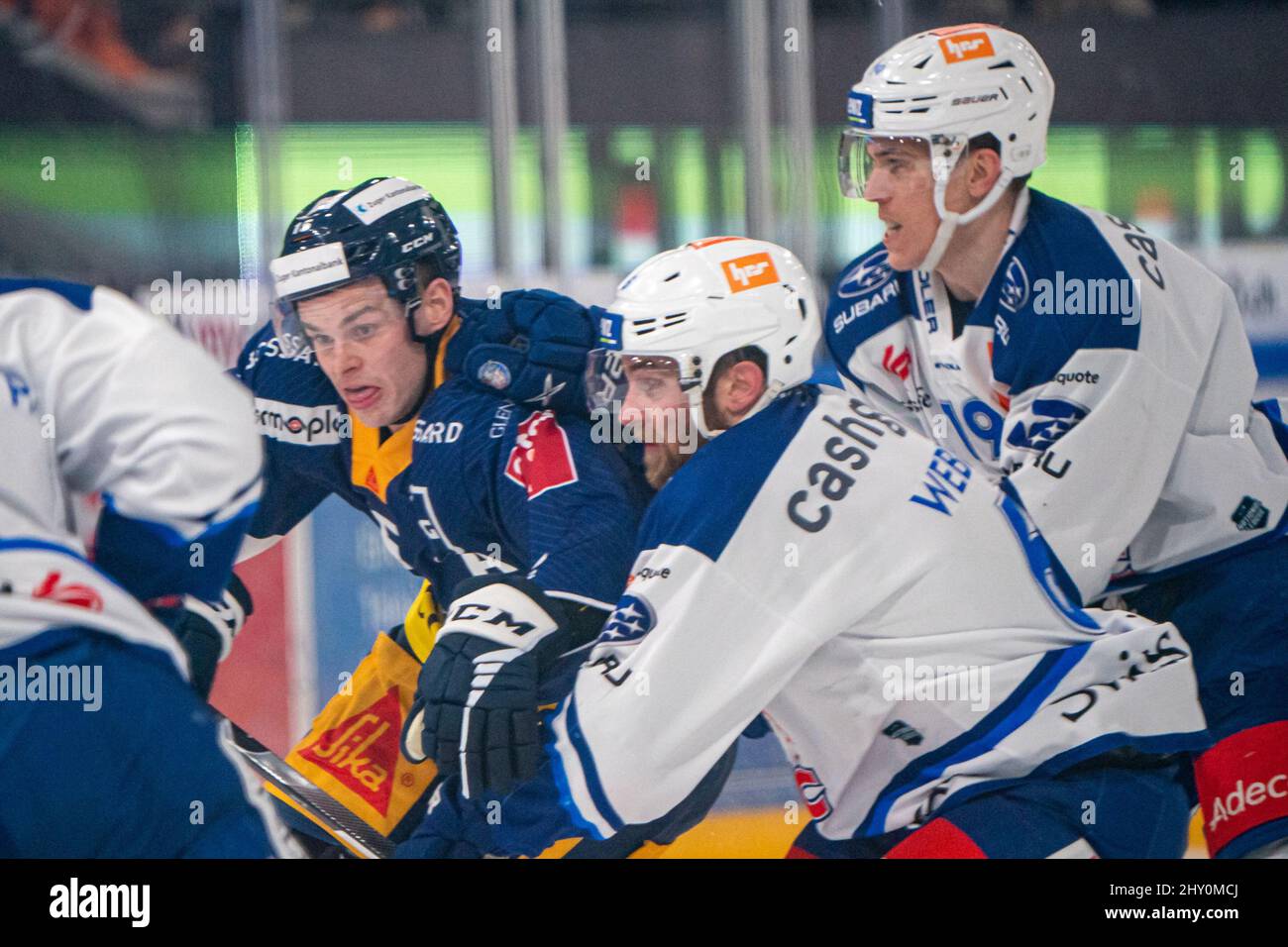#19 Reto Schaeppi (ZSC) and #6 Yannick Weber (ZSC) against Gregory Hofmann #15 (EV Zug) during ...