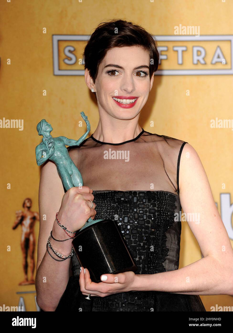 Actress Anne Hathaway poses backstage with the award for best female ...