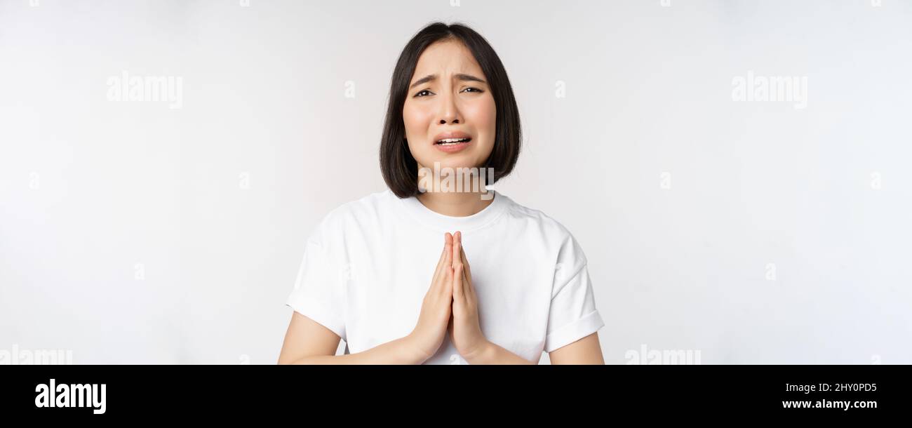 Desperate crying asian woman begging, asking for help, pleading and say ...