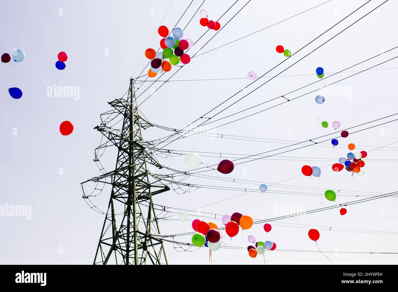 Balloons flying through electrical power lines Stock Photo - Alamy