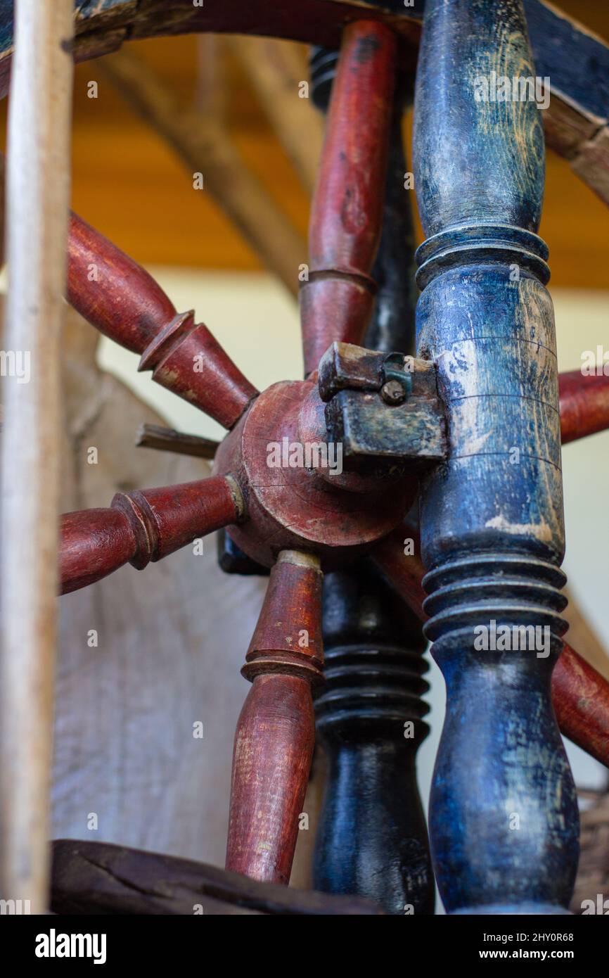 Vertical shot of an aged red-blue spinning wheel Stock Photo - Alamy