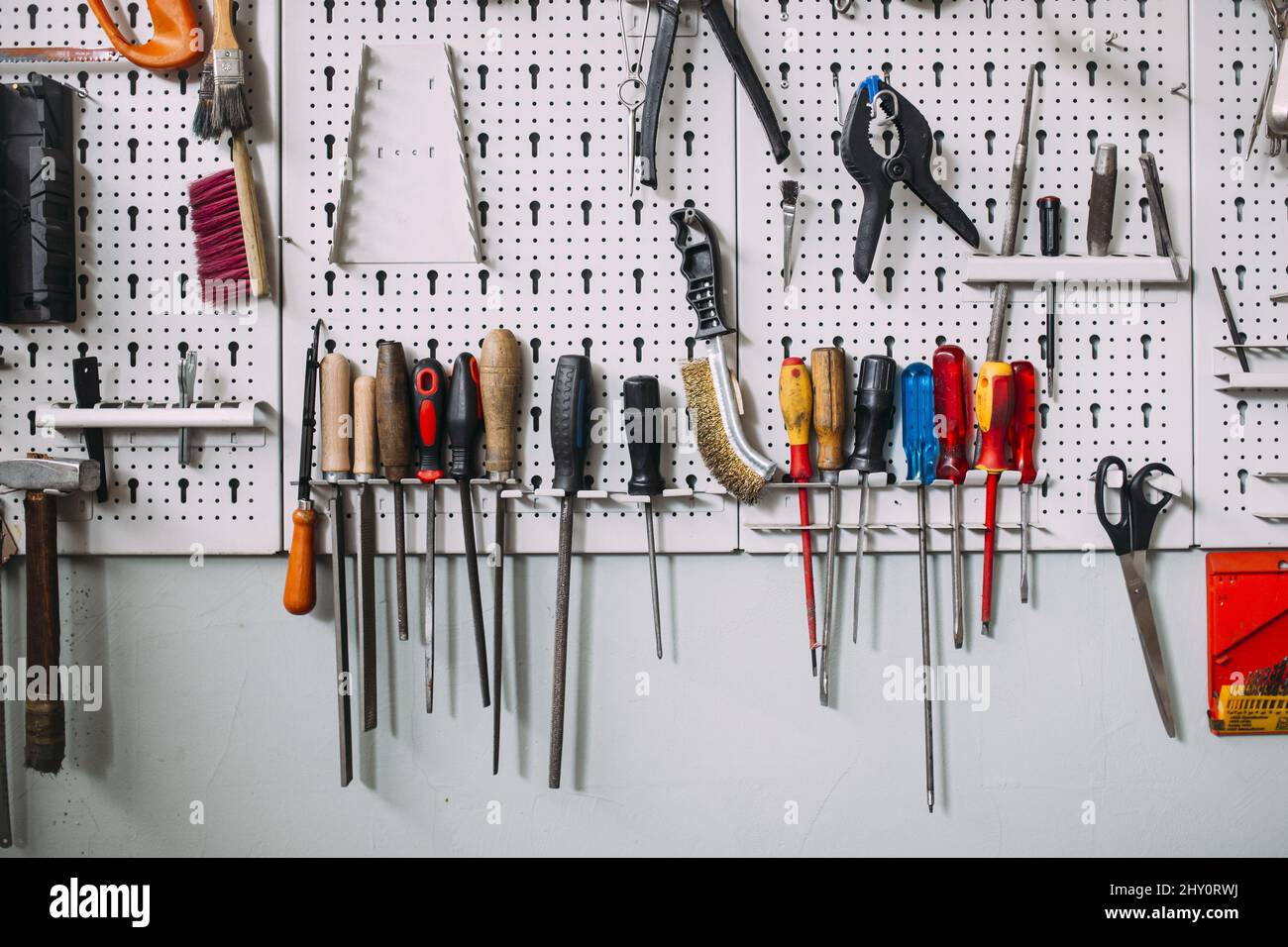 Various tools on a wall of a workshop Stock Photo - Alamy