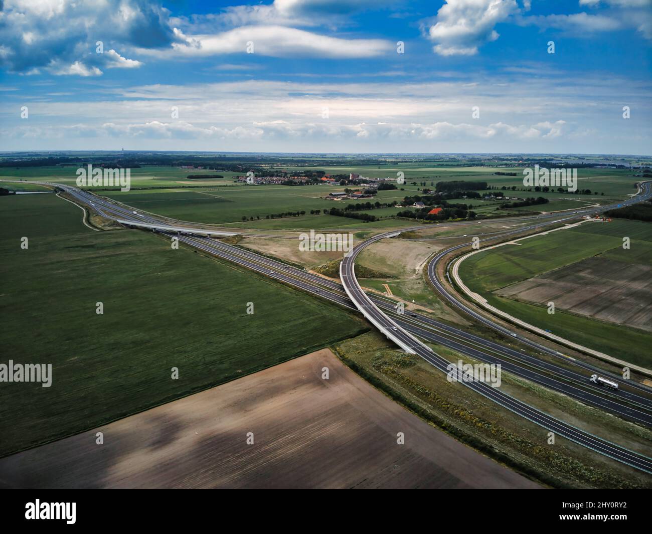 Beautiful shot of a road intersection in a forest under the cloudy ...