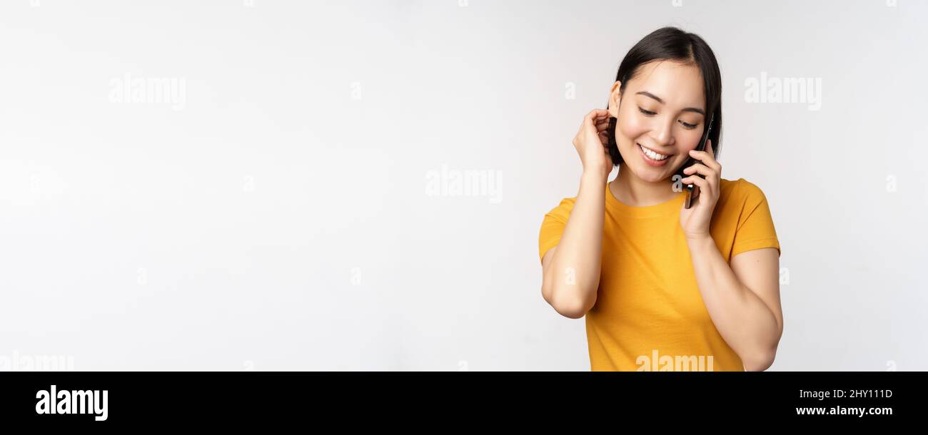 Romantic and cute asian girl answer phone call, talking on mobile ...