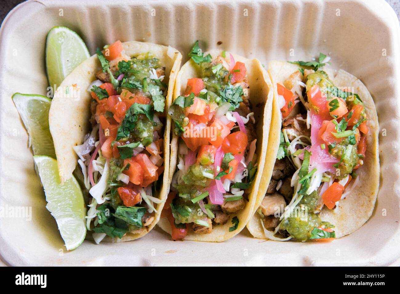 Overhead shot of street tacos with limes in take away box Stock Photo ...