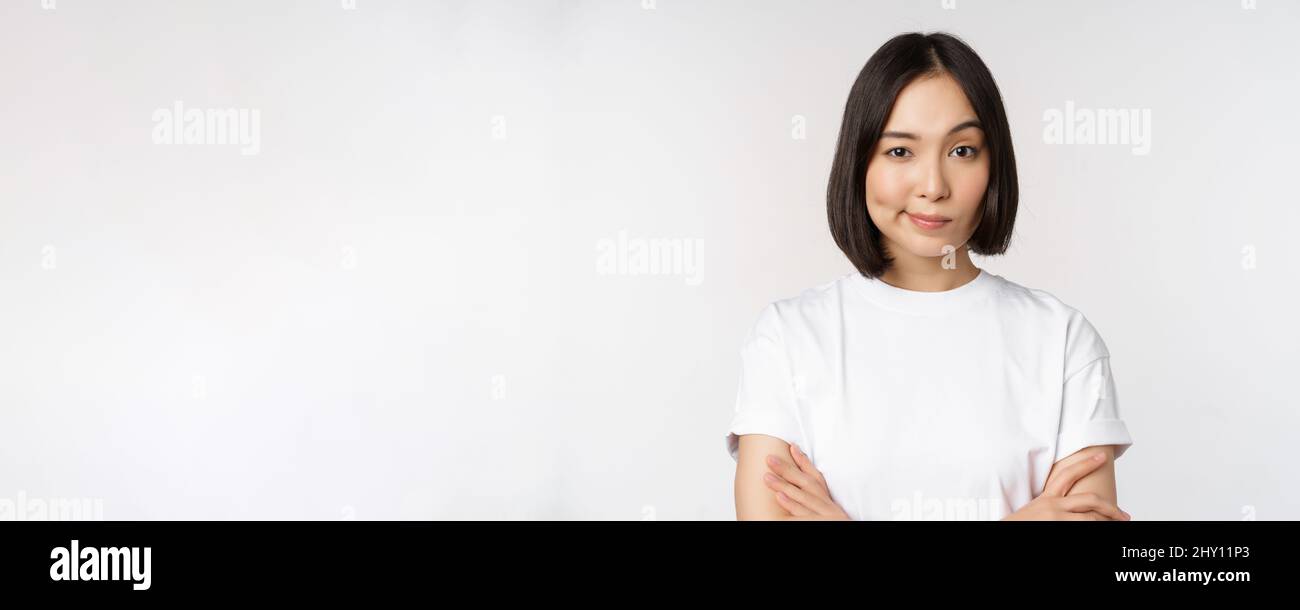 Close up of korean girl, looking skeptical, cross arms on chest and ...