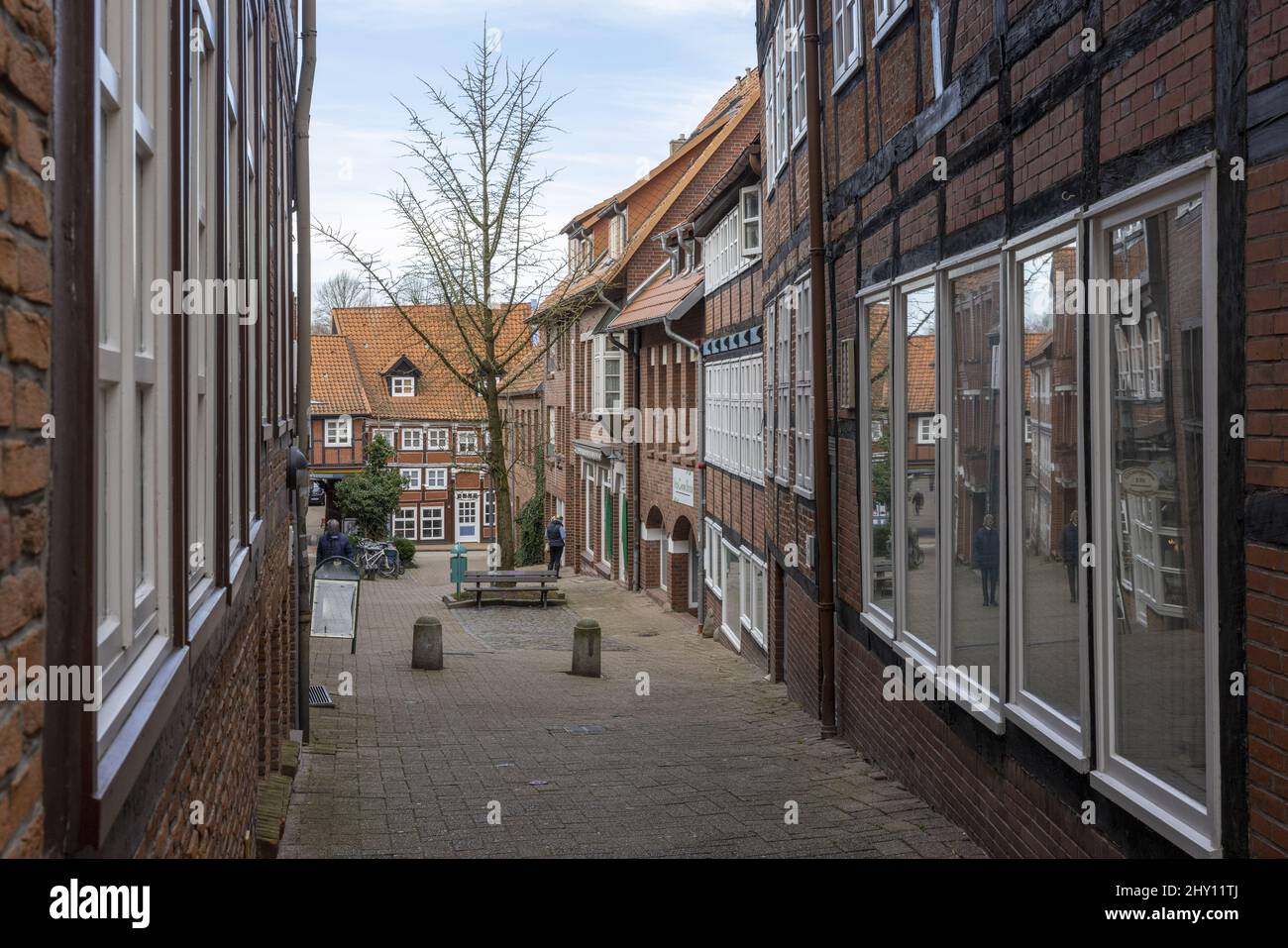 View of narrow street surrounded by buildings in Hanseatic city of ...