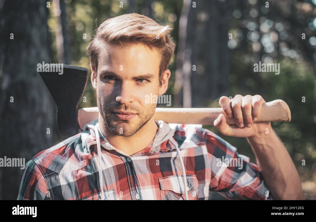 A handsome young man with a beard carries a tree. Handsome Woodworkers ...