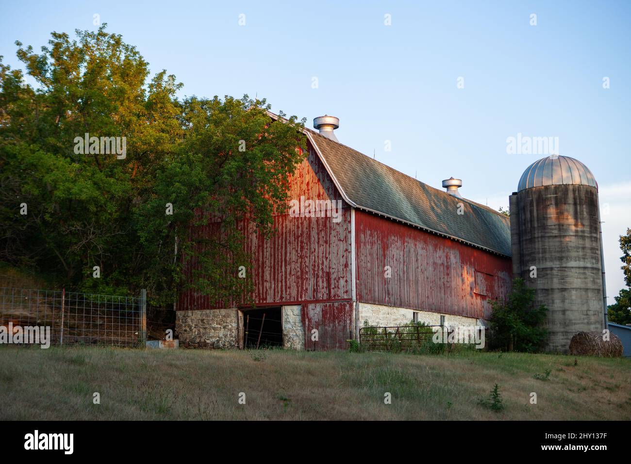 Old barn with a grain silo under a bright sky Stock Photo - Alamy