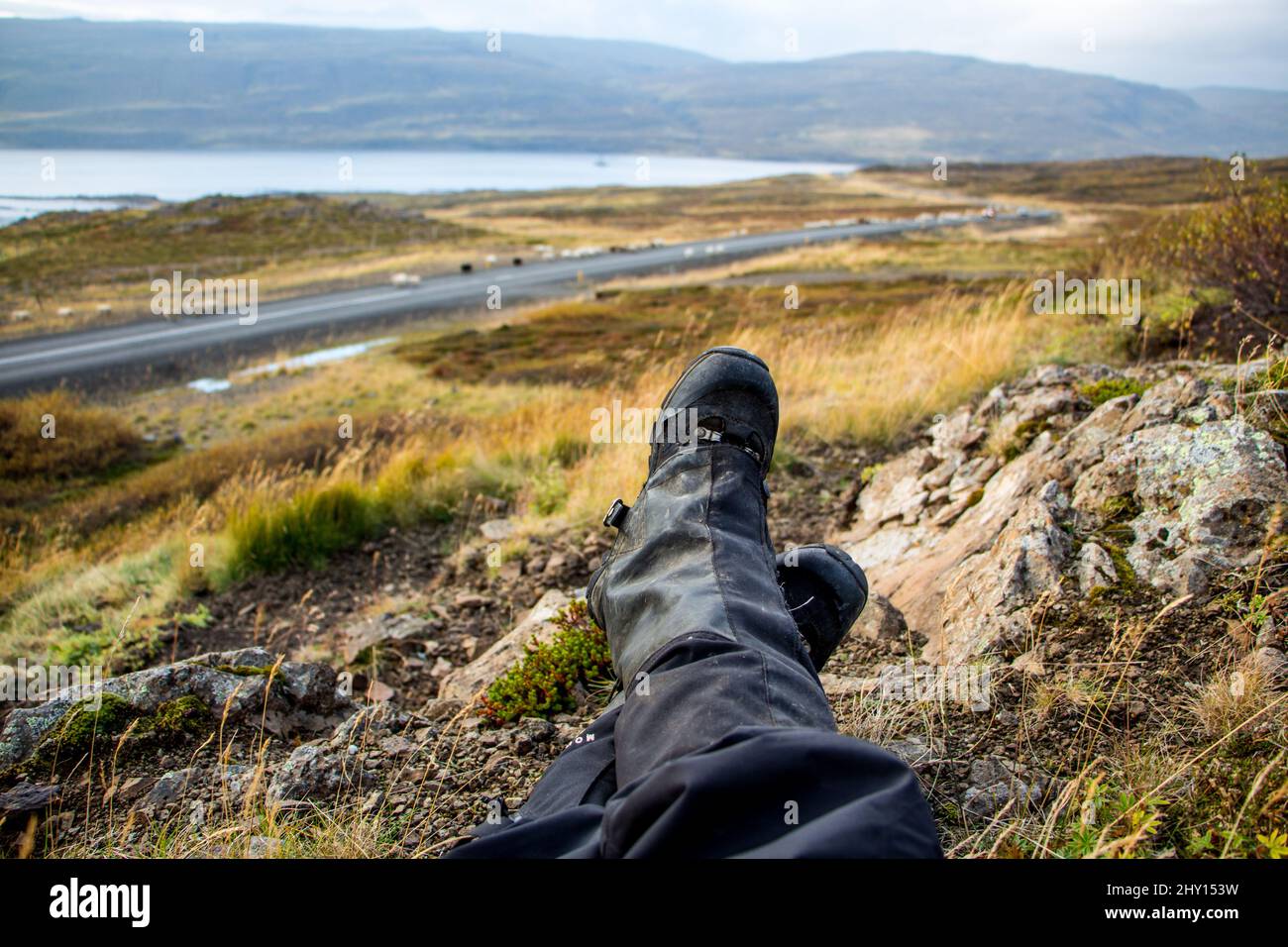 Feet in boots and a beautiful landscape in the background in Iceland ...