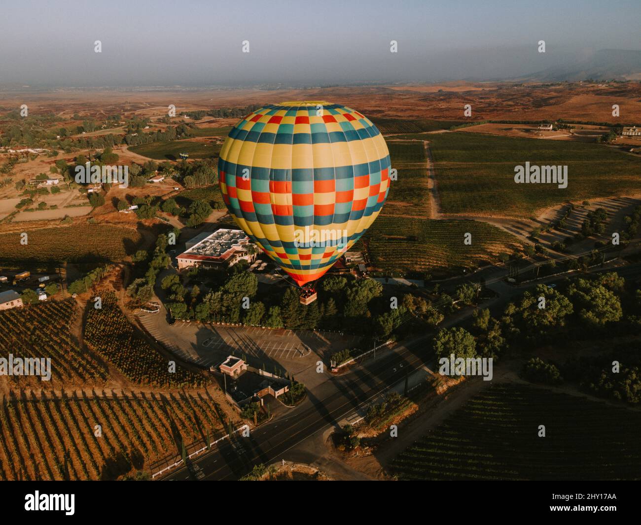 Colorful hot air balloon flying over a landscape Stock Photo - Alamy