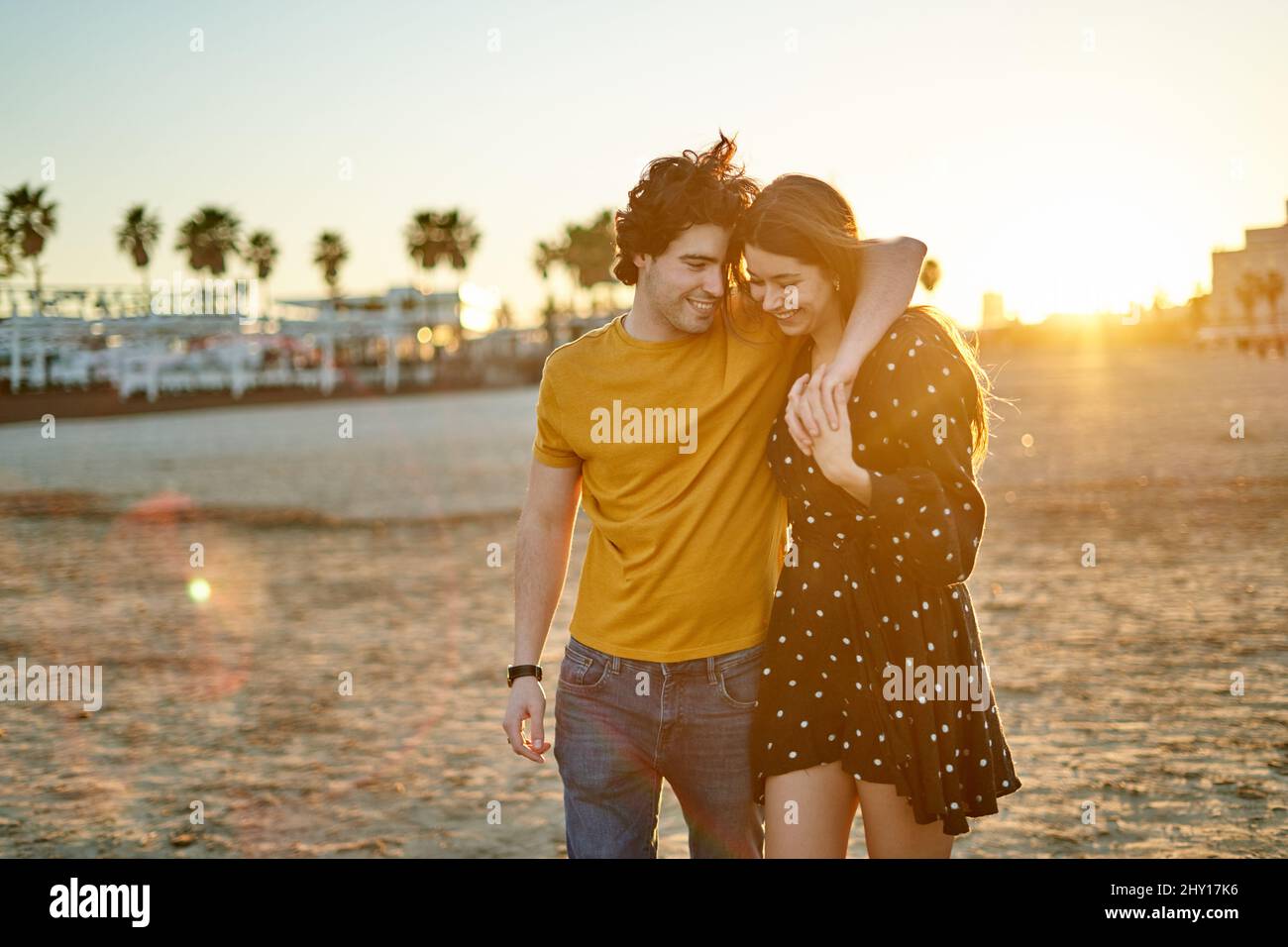 Loving couple in casual wear hugging and tenderly caressing while ...