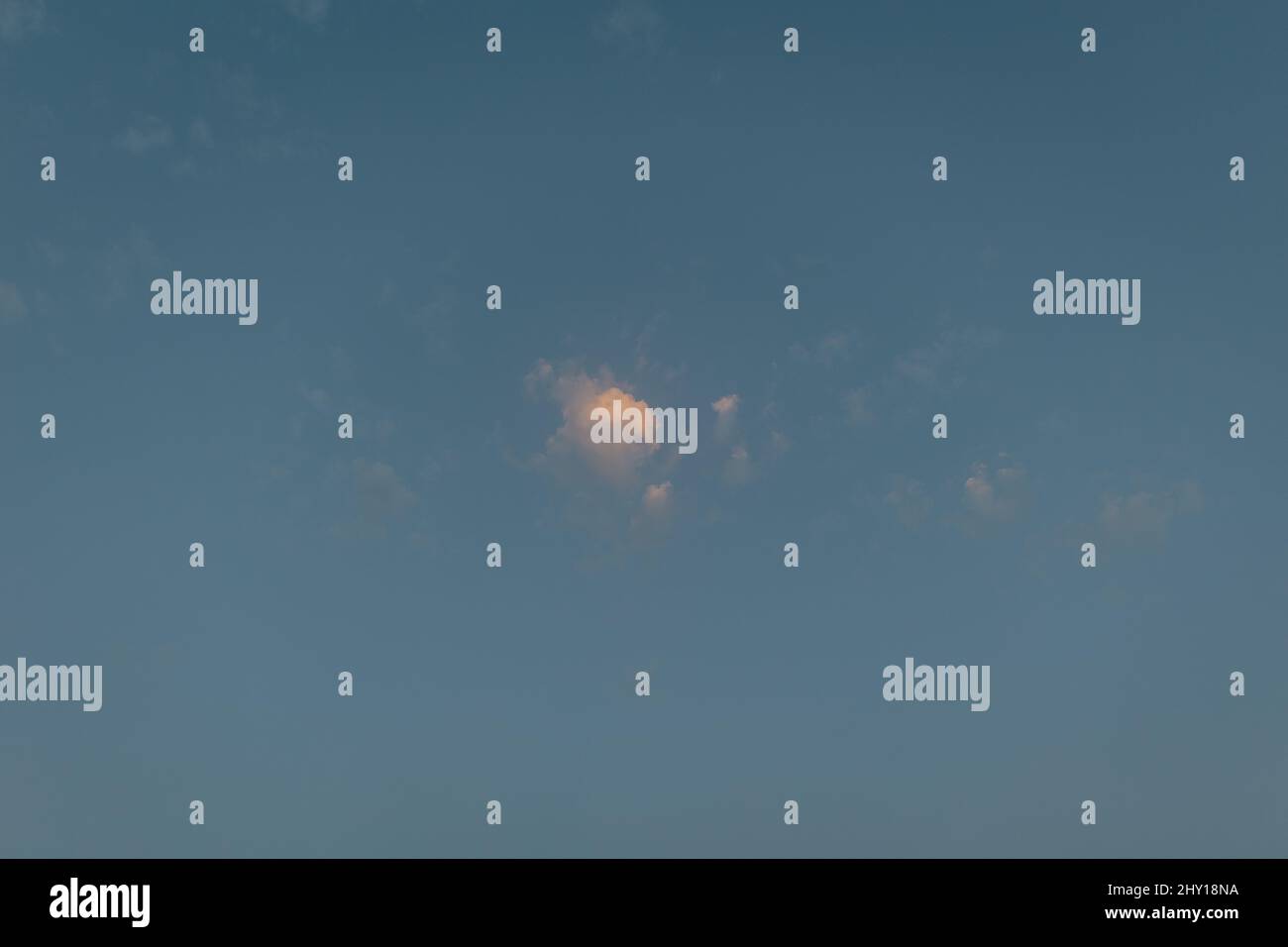 Small white fluffy clouds floating high in atmosphere in air on clear ...