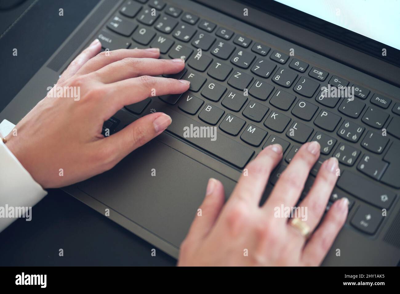 From above crop anonymous female employee browsing netbook while ...