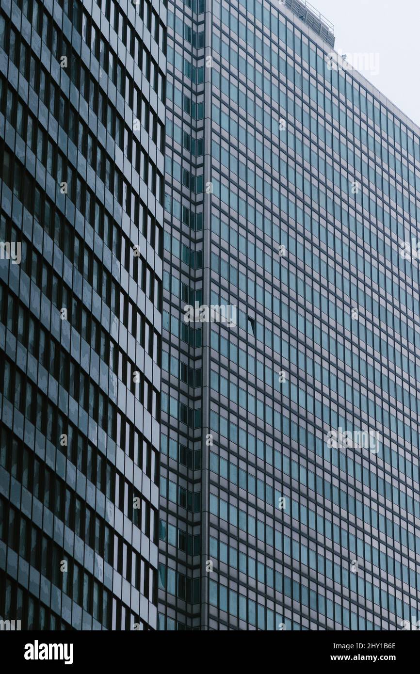 From below of contemporary high rise building with glass mirrored walls ...