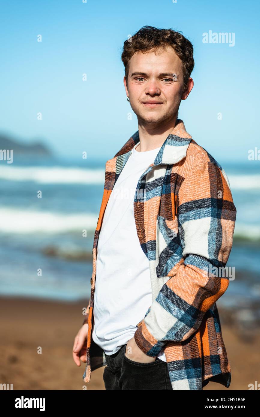Charming Hispanic lady in stylish beret holding cup of hot drink and ...