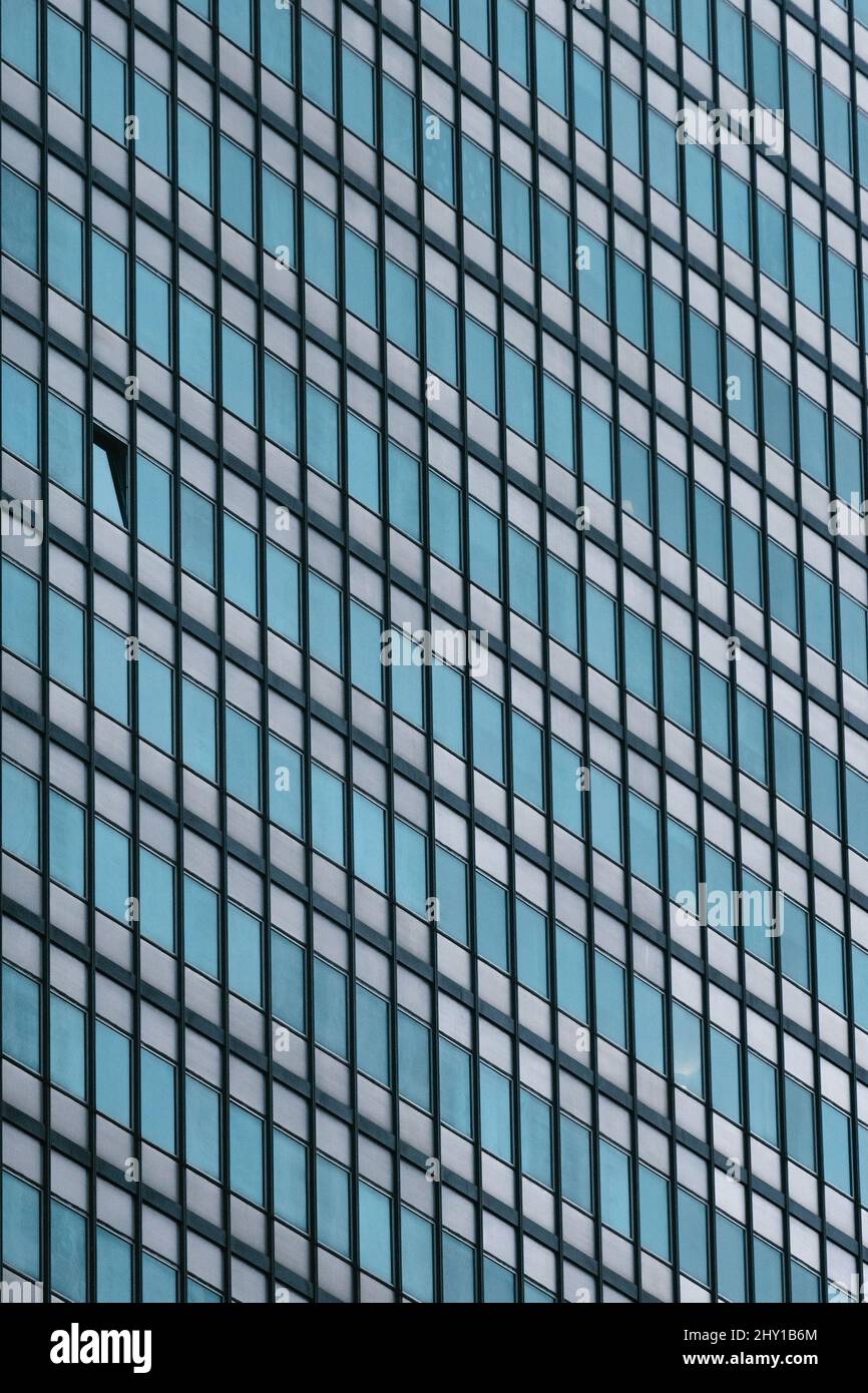 High rise building with glass mirrored walls located on street of ...