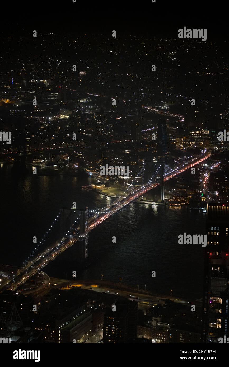 From above of glowing bridge crossing river in New York city with ...