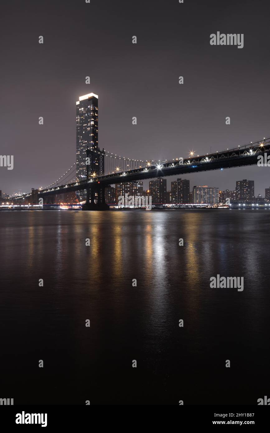 Side view of anonymous male standing near sink in bathroom and washing ...