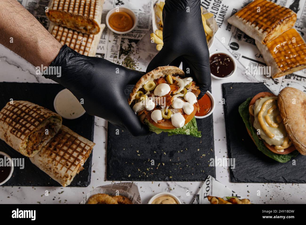 From above of crop anonymous male chef in gloves showing delicious ...