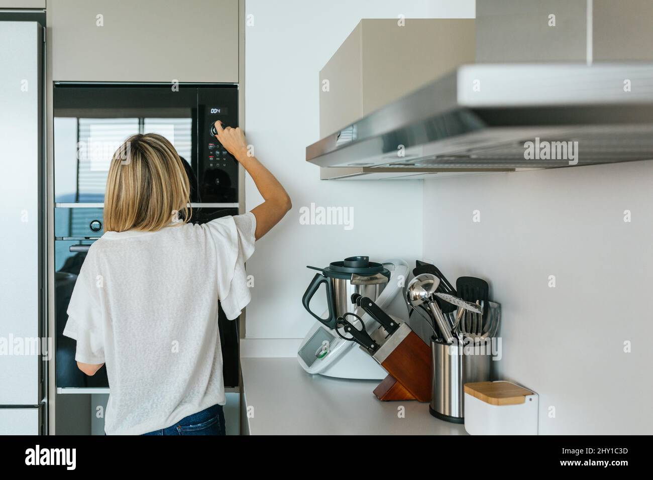 Young female athlete doing stretching exercise near glass railing ...