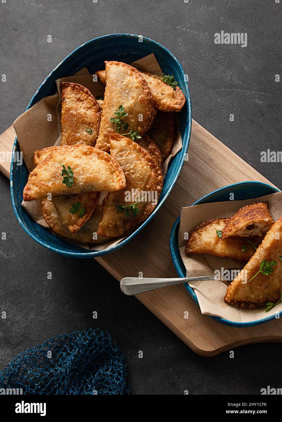 Top view delicious plate of dumplings and empanadas on a black table ...