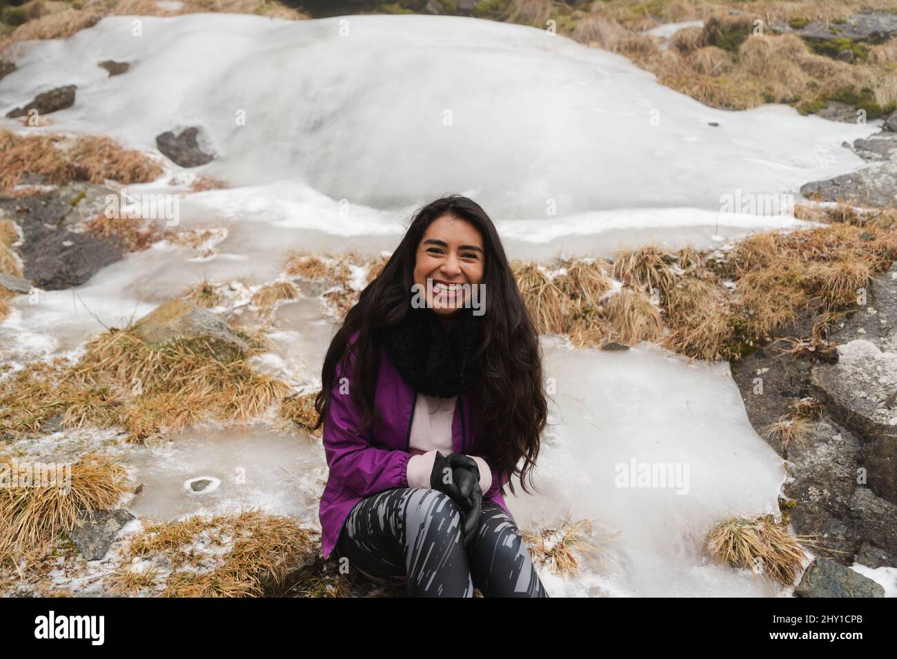 Happy Hispanic female traveler looking at camera with smile while ...