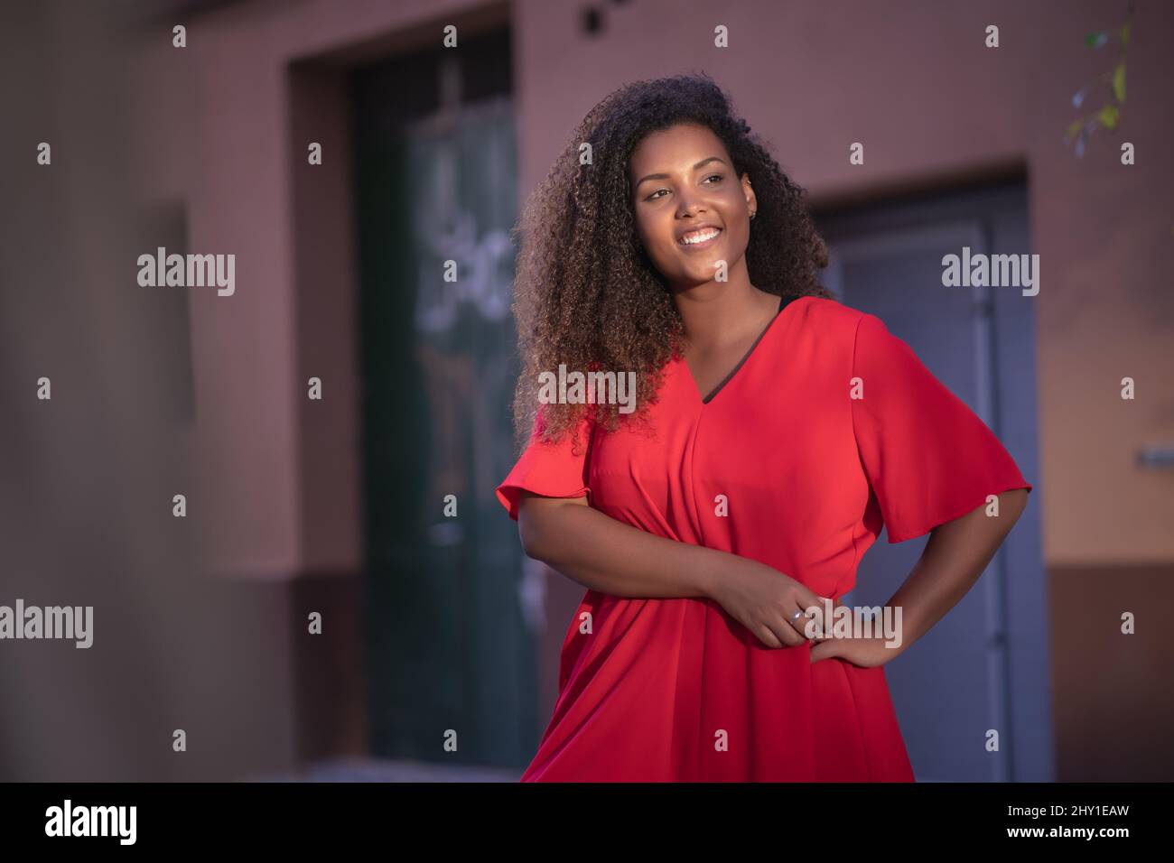 Charming African American female with black hair in red outfit with ...