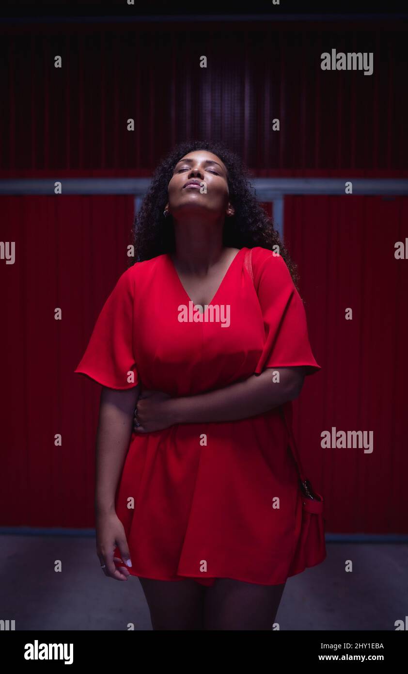 Charming African American female with black hair in red outfit with ...