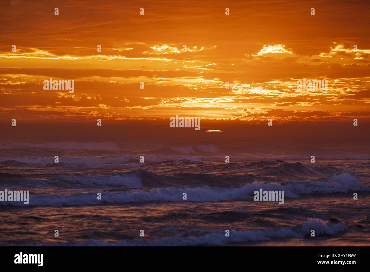 Beautiful shot of a bright sunset sky over a beach in Van Stadens ...