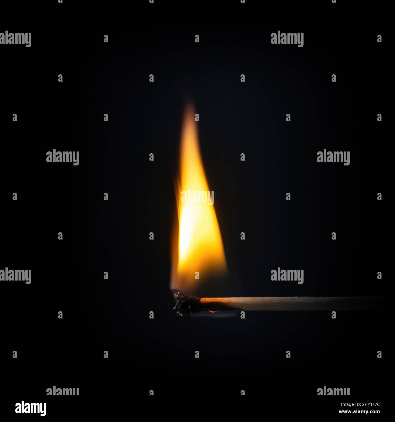 Wooden match stick flame on a black background Stock Photo - Alamy