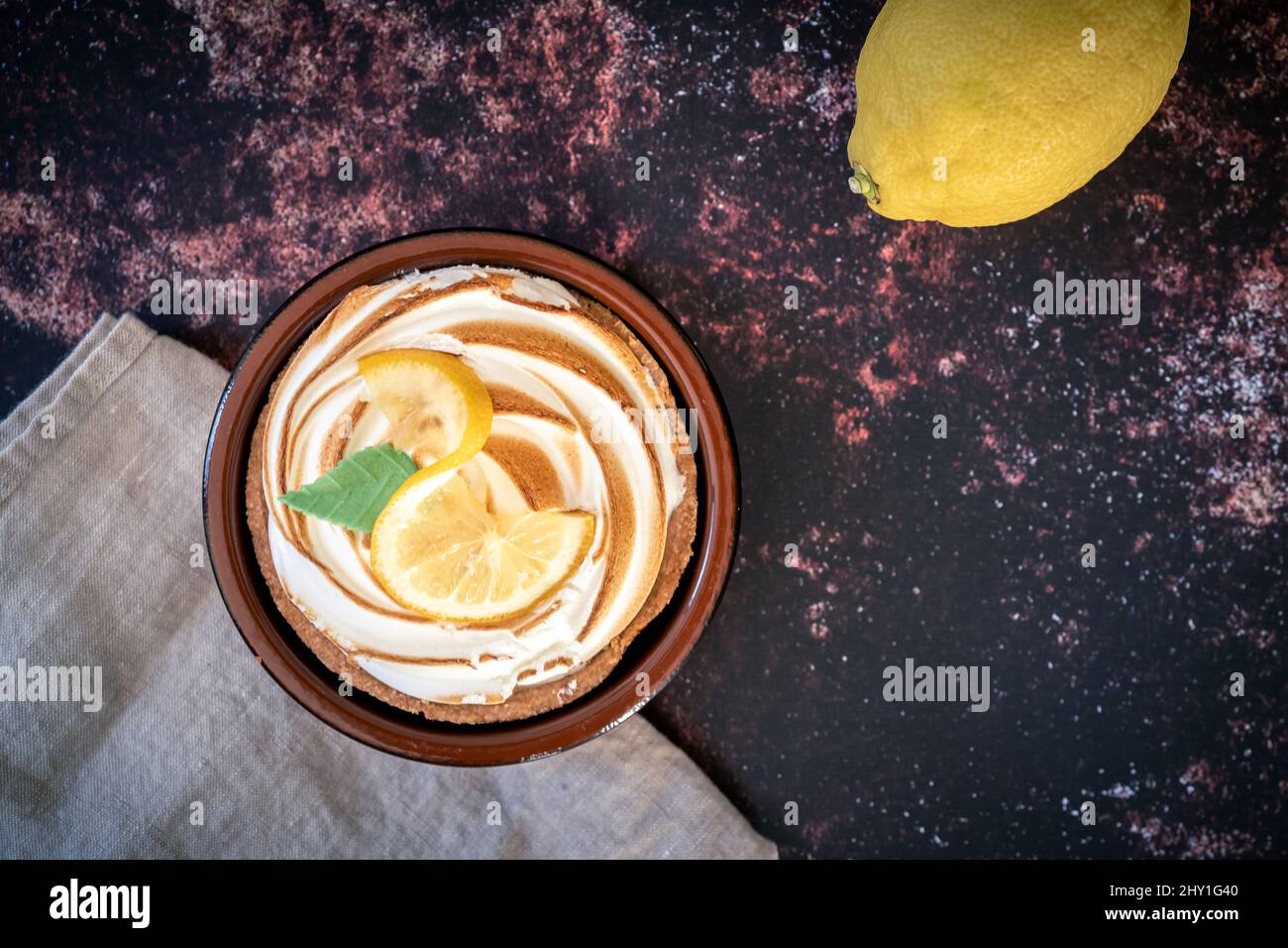 Traditional french lemon tart on a dark rusty table. lemon and napkin ...