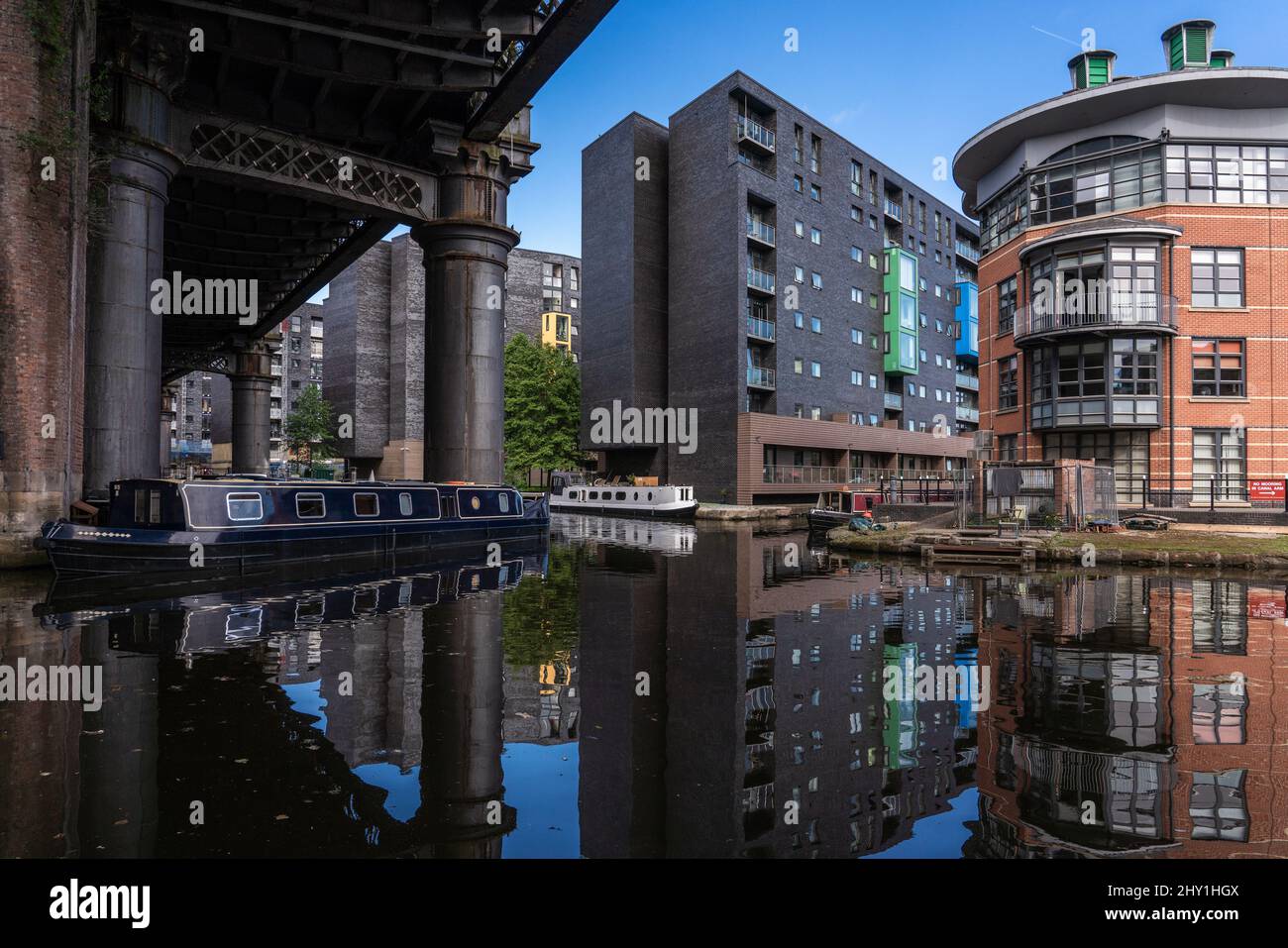 Castlefield cityscape of modern riverside buildings under an historic ...