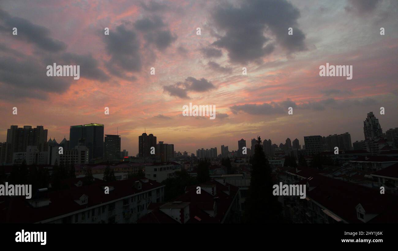 Beautiful orange sunset over the city with tall buildings Stock Photo ...