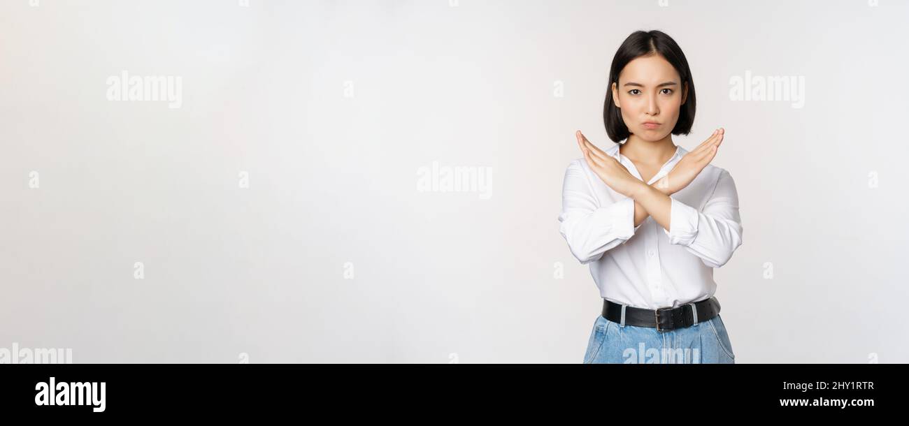 Image of young asian, korean girl student showing stop, cross ...