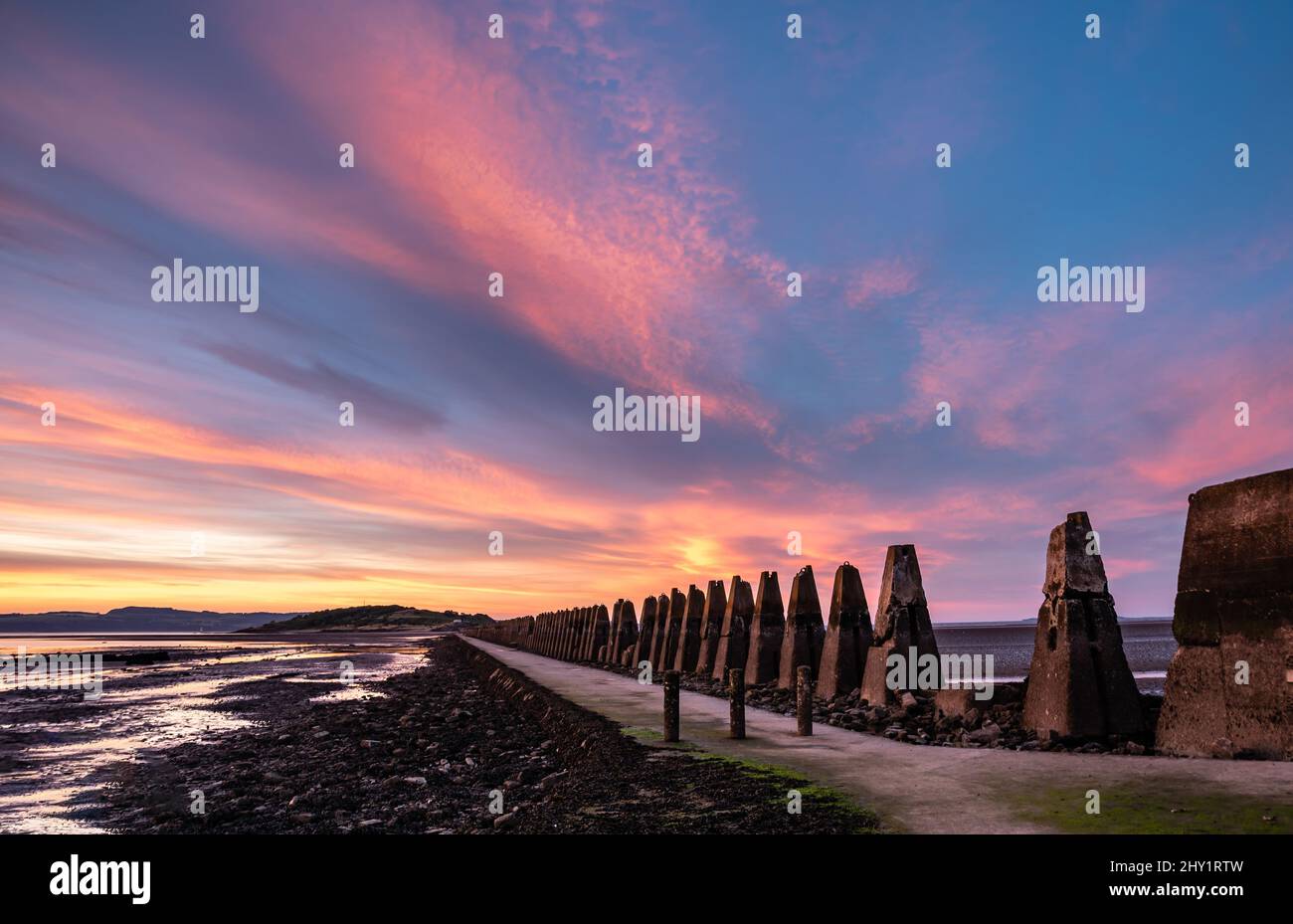 Beautiful view of a pink sunset over the beach in Cramond Island ...