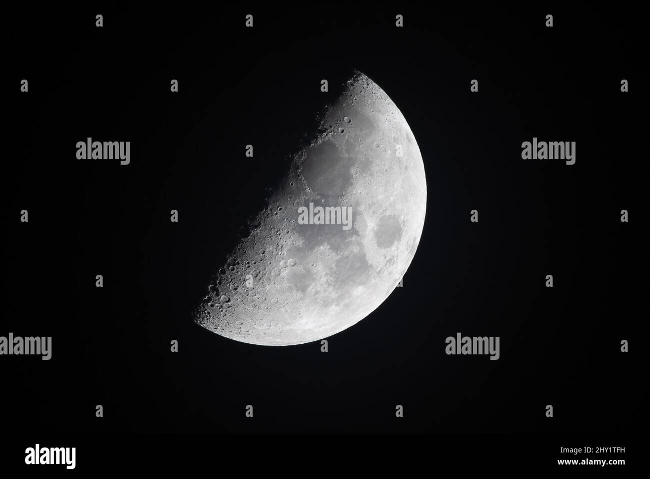 Half moon through telescope on dark night sky Stock Photo - Alamy
