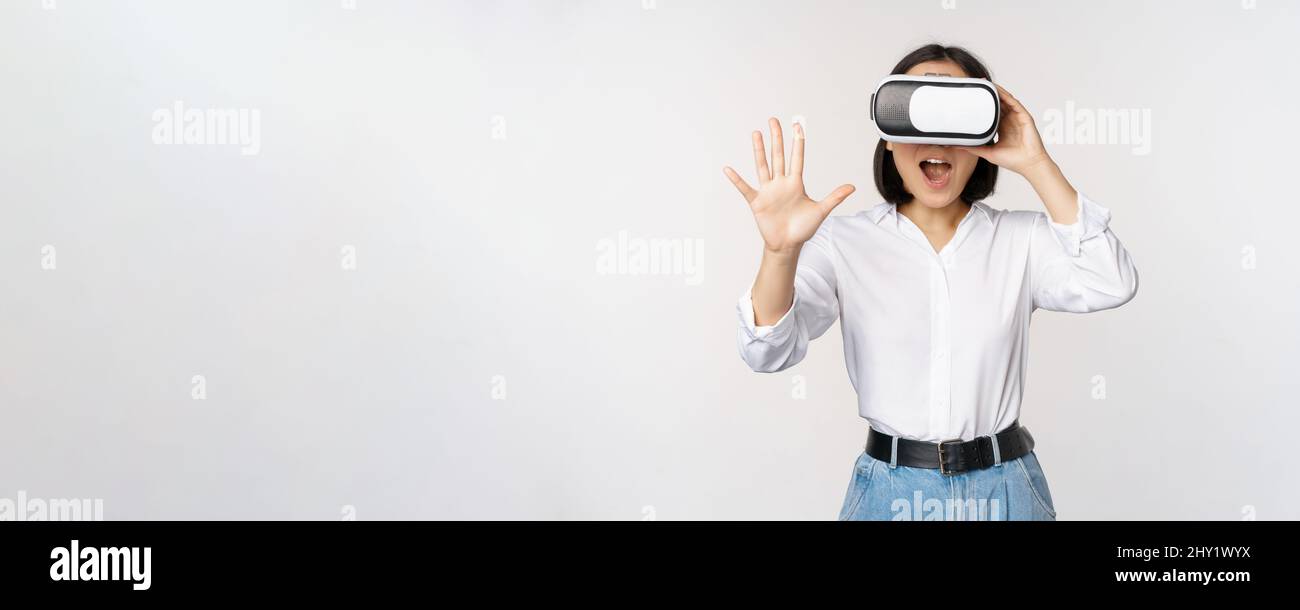 Vr chat. Asian girl saying hello in virtual reality glasses, smiling ...