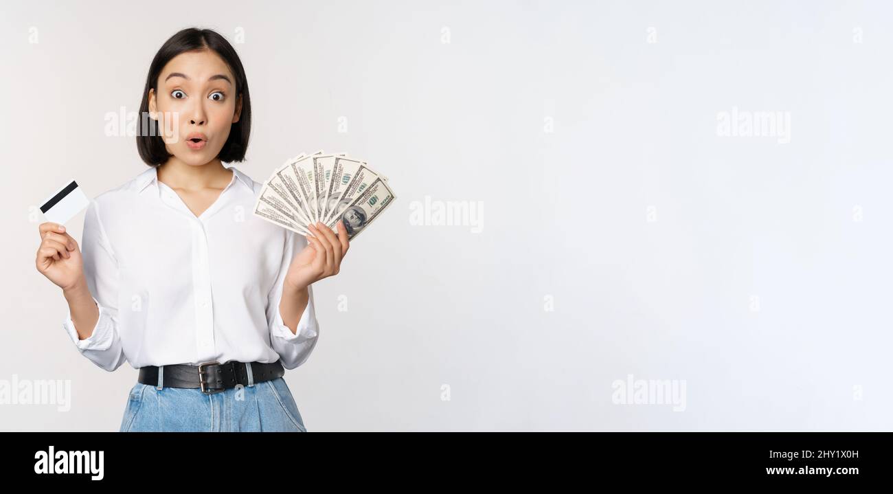 Finance and money concept. Happy young asian woman dancing with cash ...